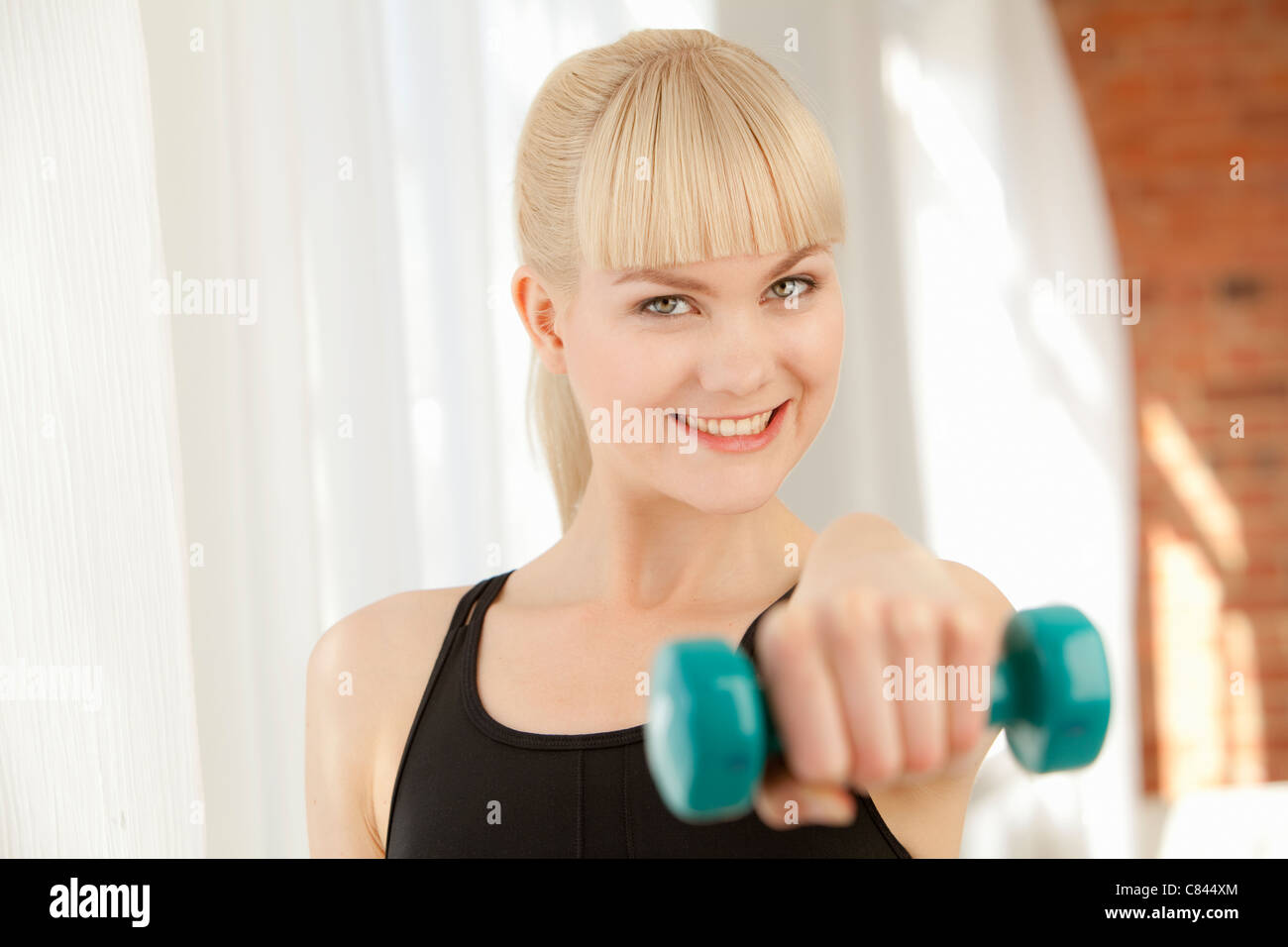 Woman lifting hand weights Stock Photo - Alamy