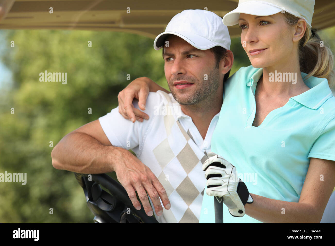 Couple playing golf Stock Photo - Alamy