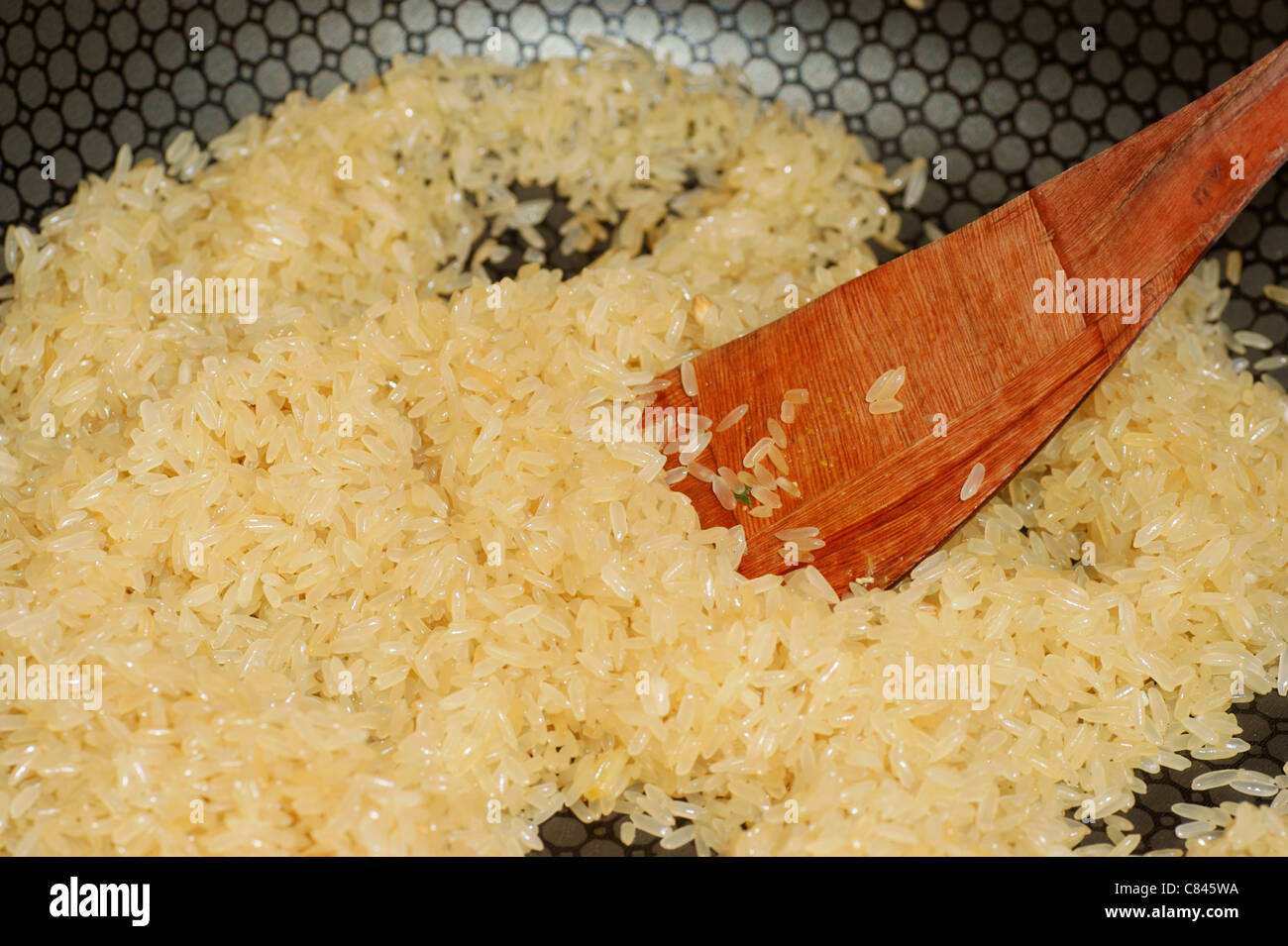 rice on frying pan, skillet, wood spoon Stock Photo - Alamy