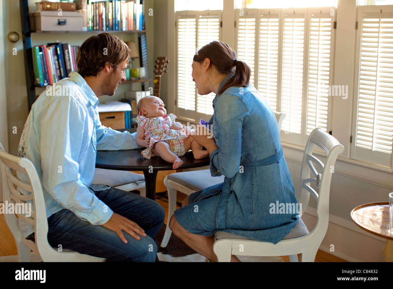 Happy Caucasian parents admiring baby daughter Stock Photo - Alamy