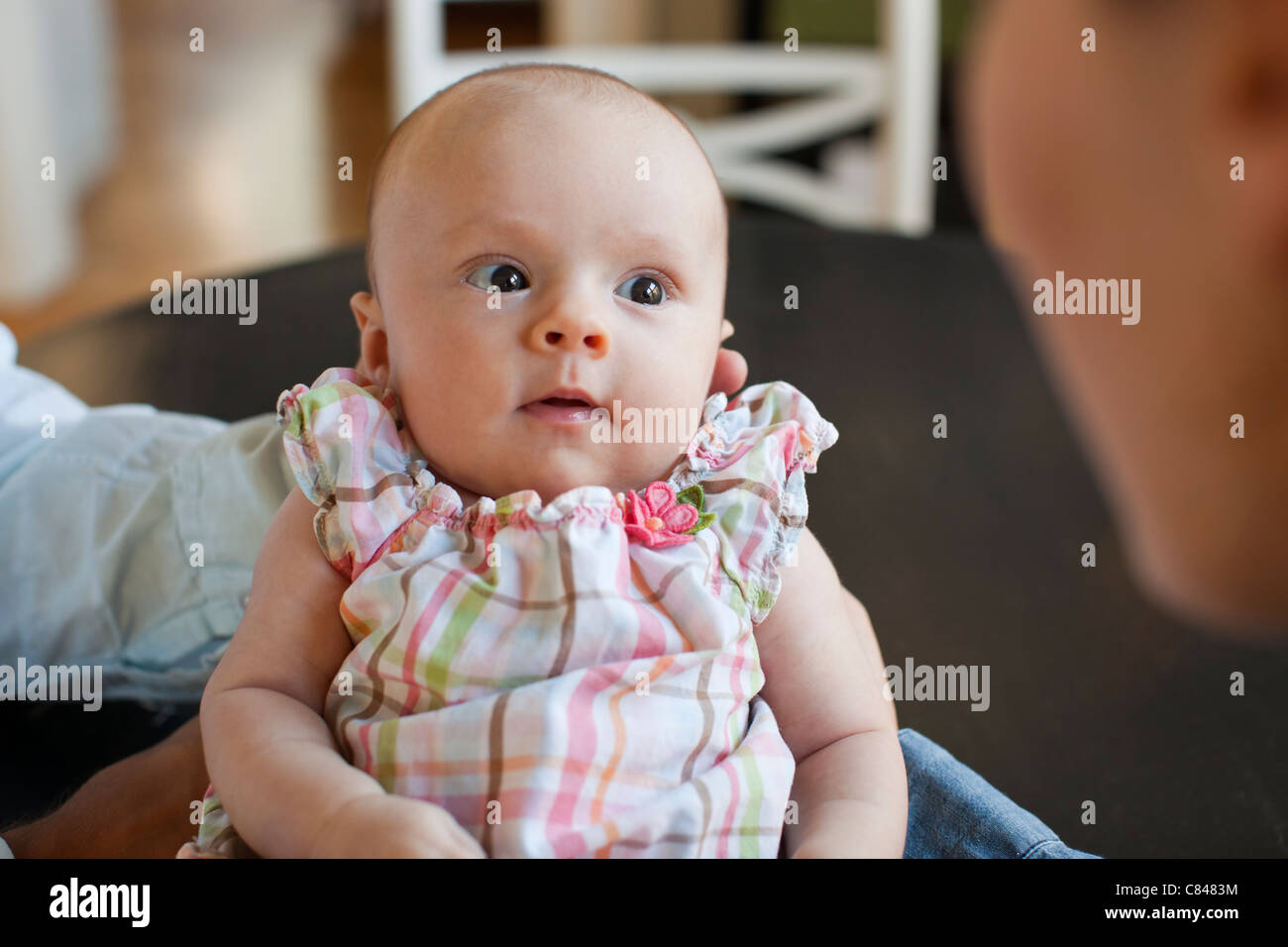 Caucasian parents admiring baby daughter Stock Photo - Alamy