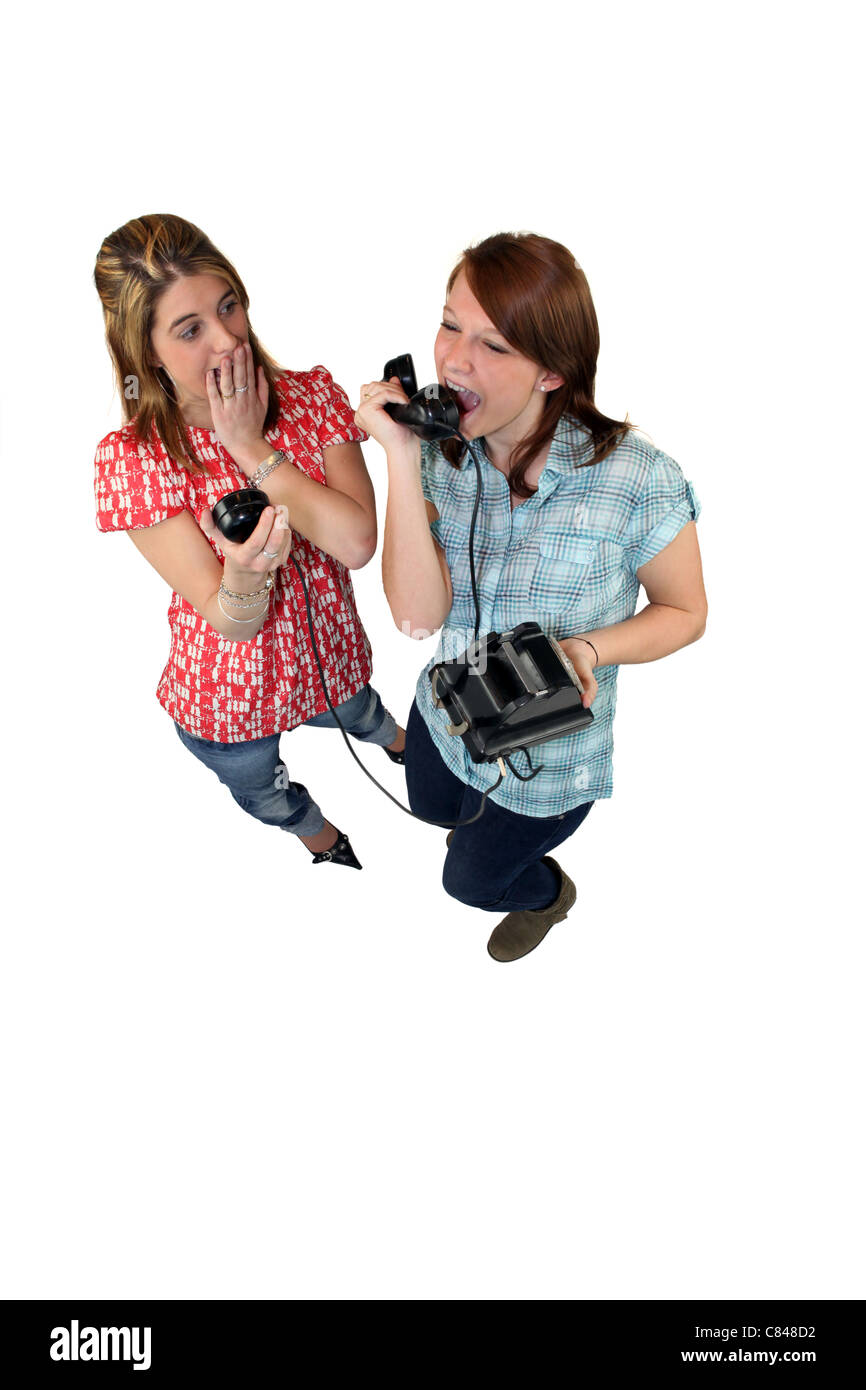 Girl screaming down an old fashioned phone Stock Photo - Alamy