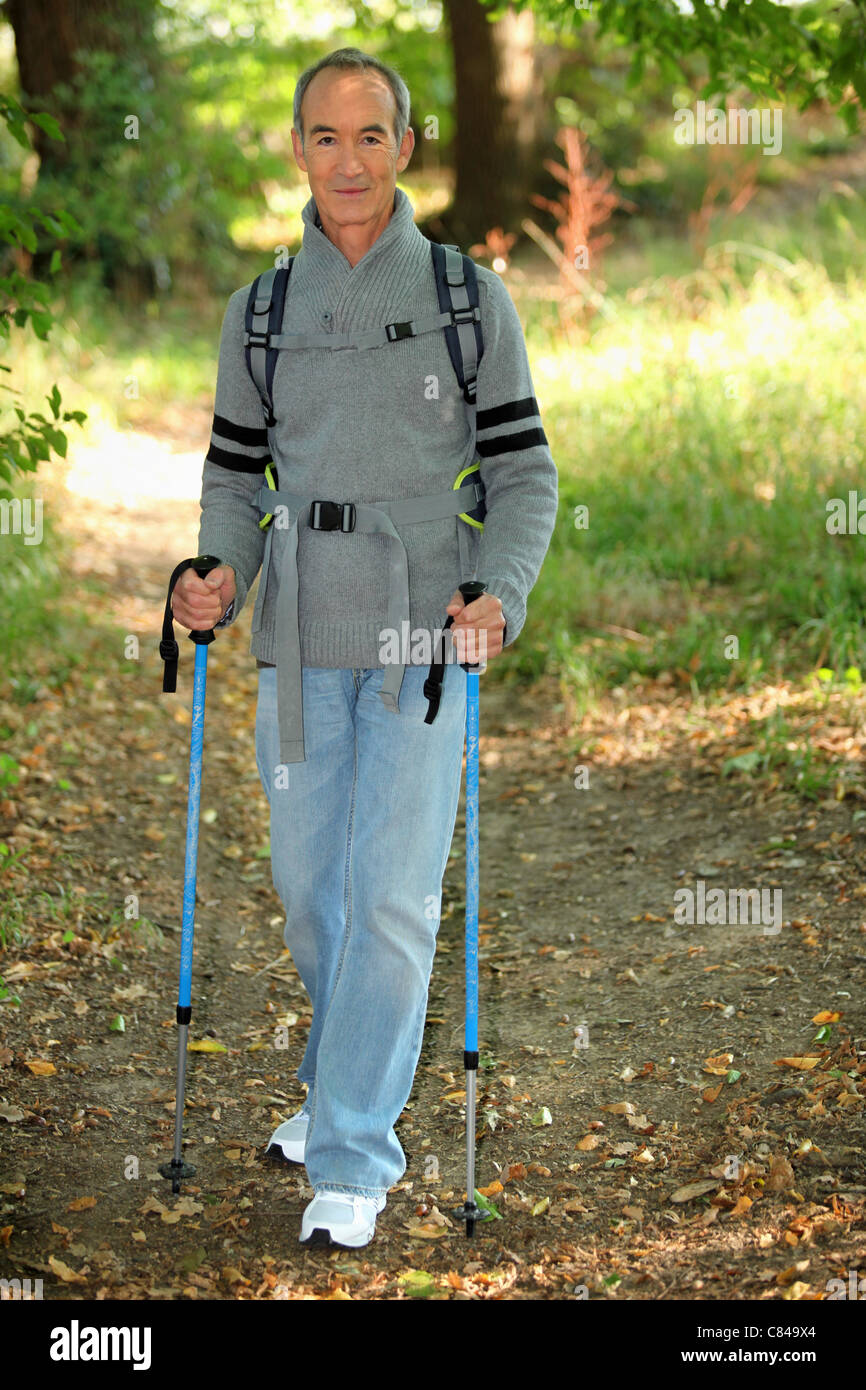 senior gentleman in forest with rambler walking poles Stock Photo - Alamy