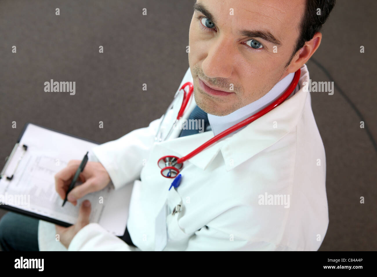 a doctor writing on a paper Stock Photo - Alamy