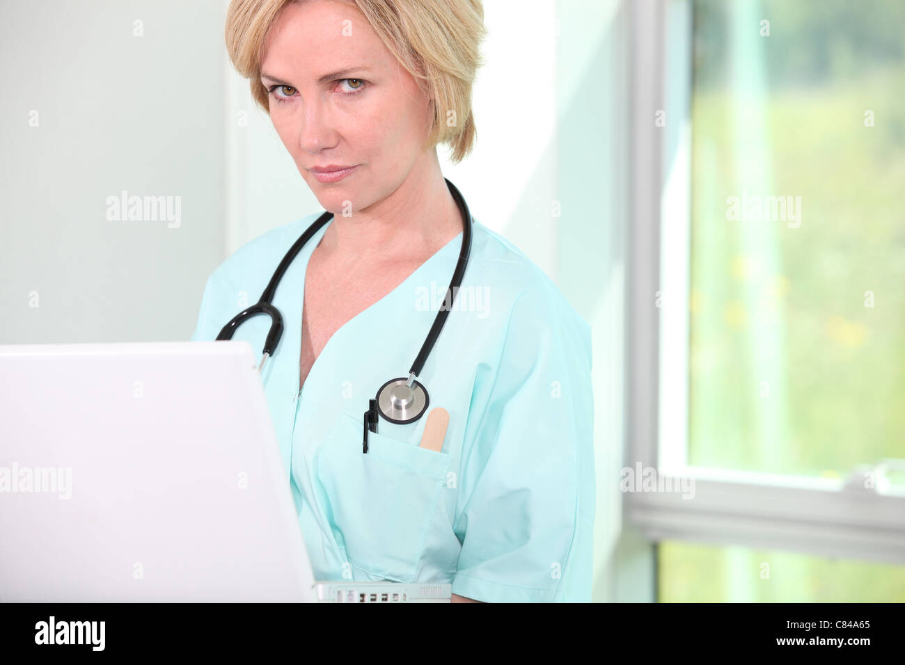 Nurse on laptop Stock Photo - Alamy