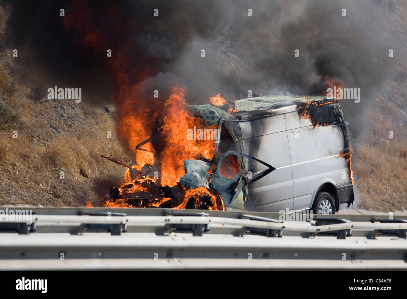 Burning van with large flames and black smoke Stock Photo - Alamy