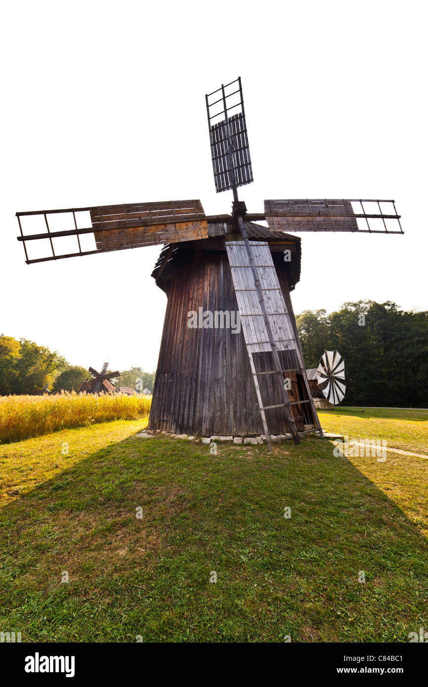 Ancient wind mill replica on a meadow at sunset Stock Photo - Alamy
