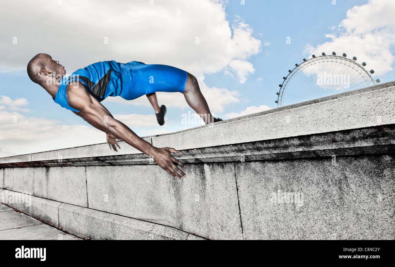 Man jumping over stone wall hi-res stock photography and images - Alamy