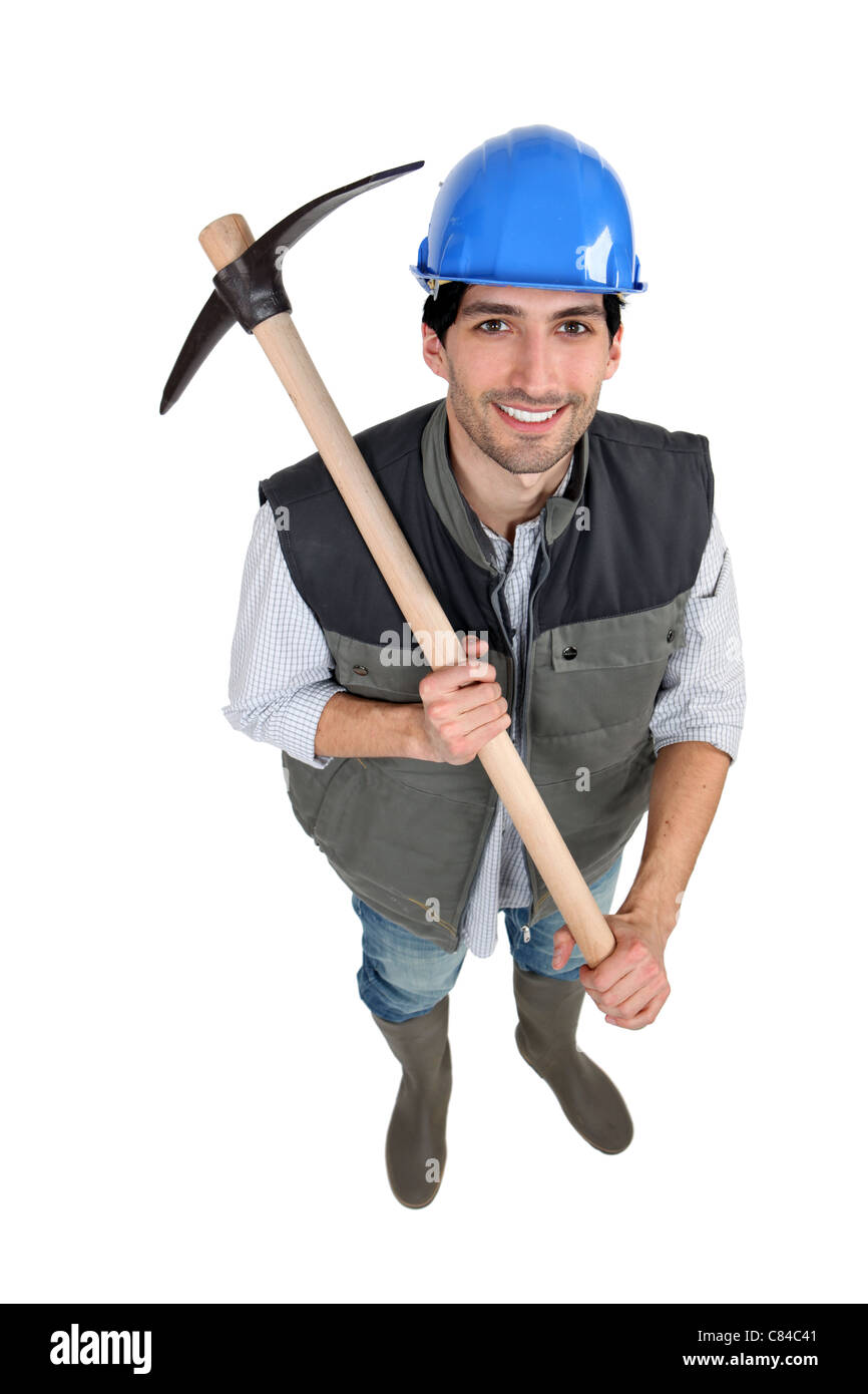 A manual worker with a pickaxe Stock Photo - Alamy