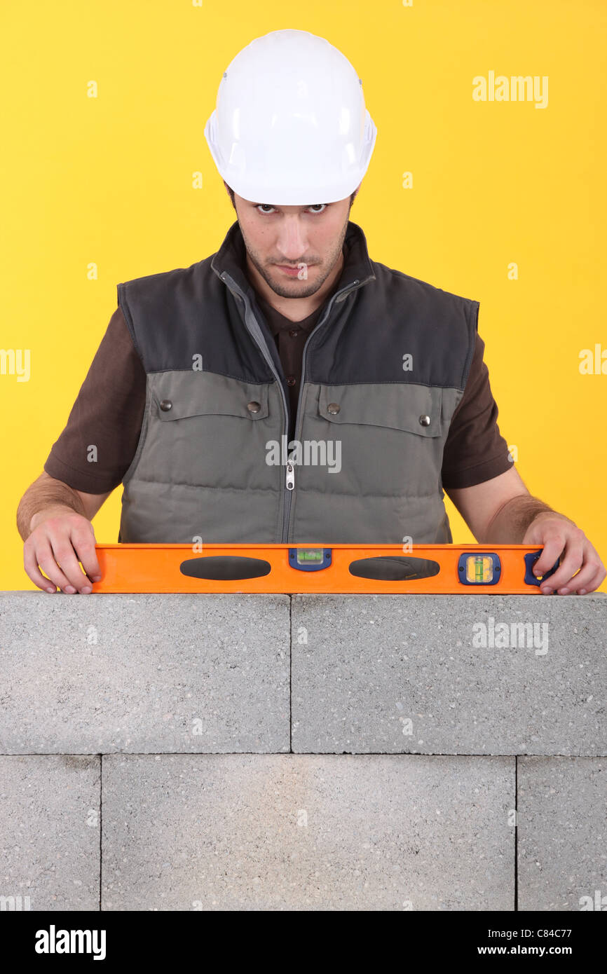 Construction worker measuring an angle with a spirit level Stock Photo ...