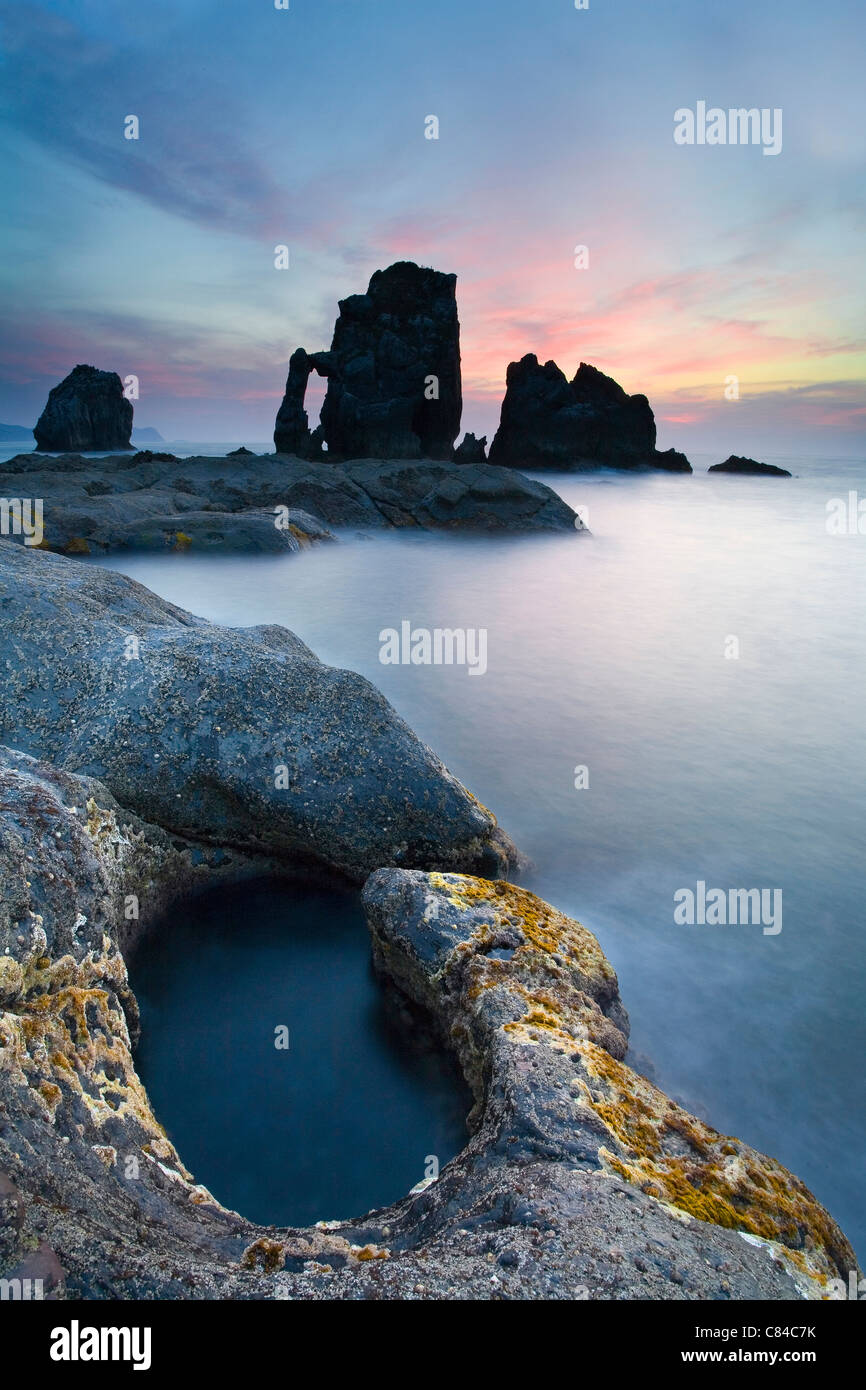 Curved stone formations on still water Stock Photo - Alamy