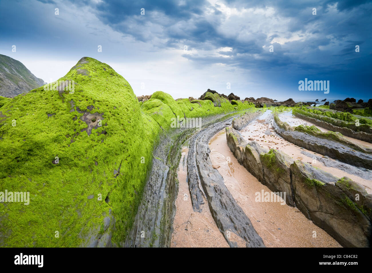 Curved stone formations on beach Stock Photo - Alamy