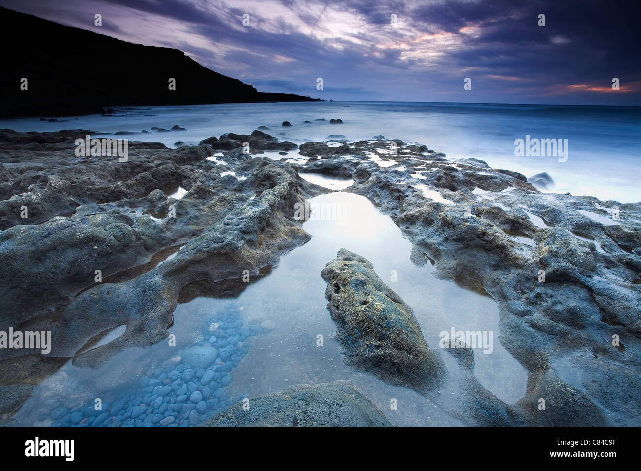 Curved stone formations in water Stock Photo - Alamy