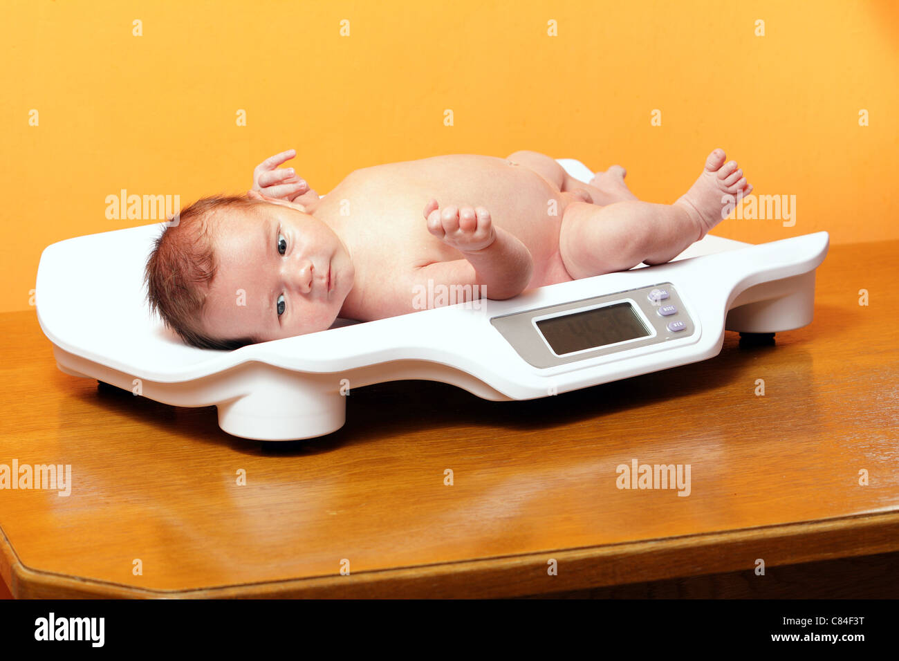 baby boy on weight scale Stock Photo - Alamy