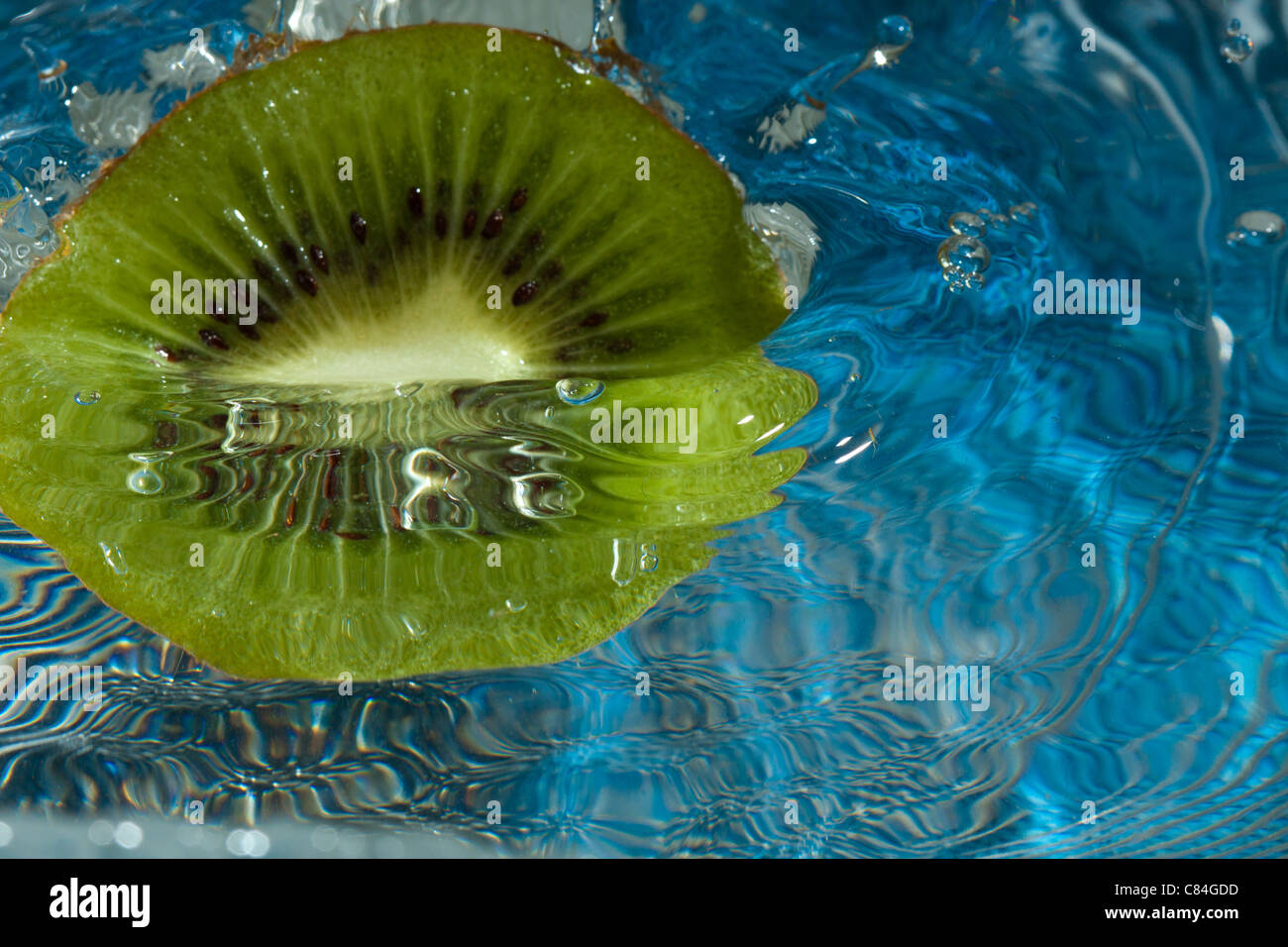 Kiwi with water drops with splashing Stock Photo - Alamy