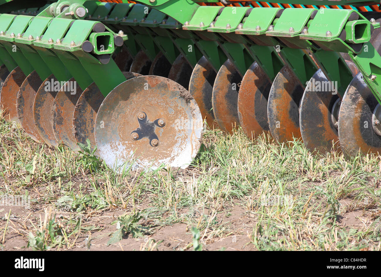 disc harrow behind tractor turning the soil Stock Photo - Alamy