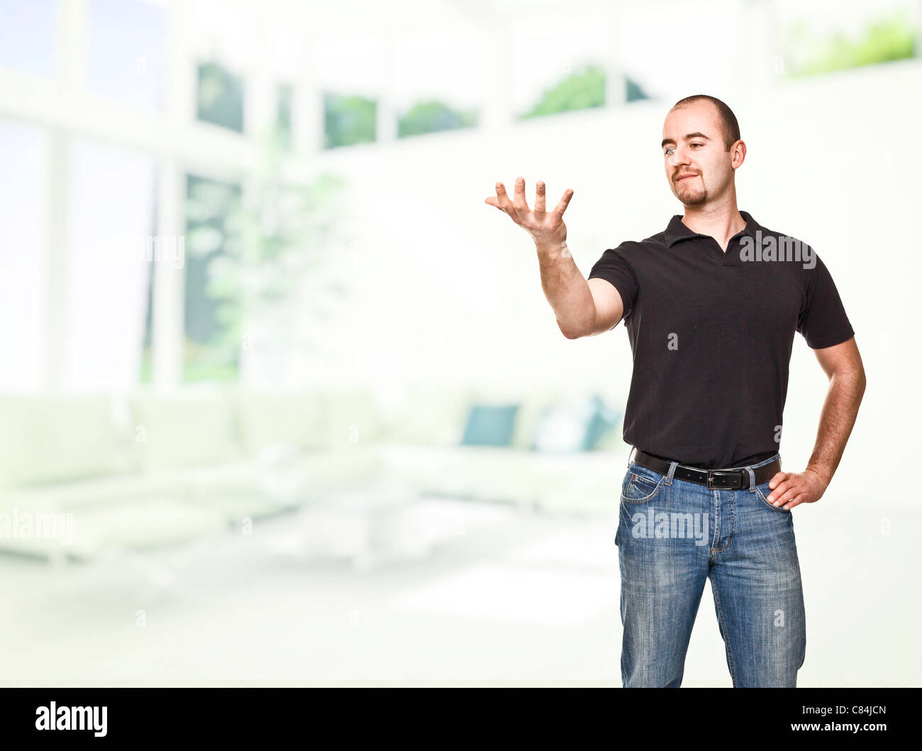 standing caucasian man looking his hand Stock Photo - Alamy