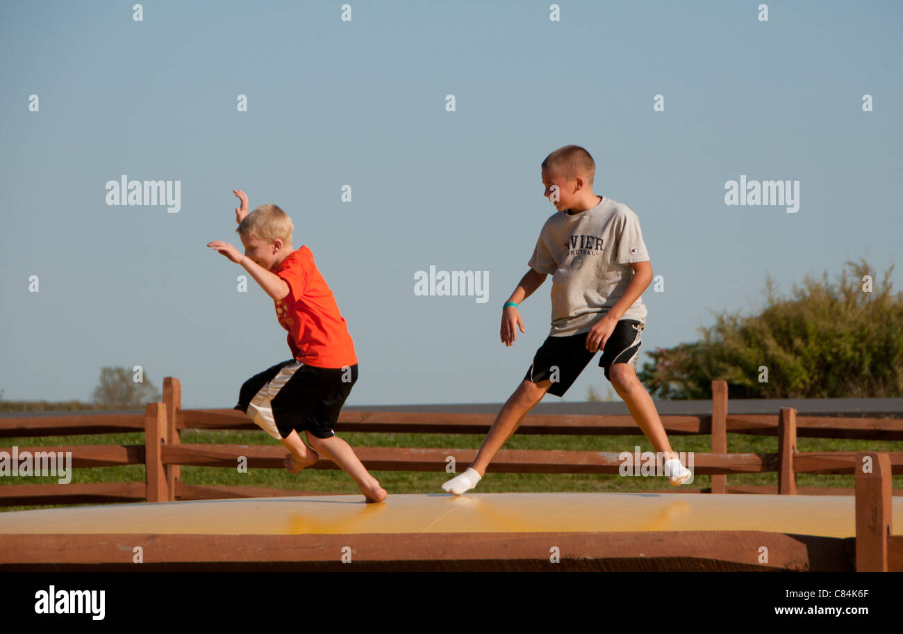 Children jumping on giant rubber pillow Stock Photo - Alamy
