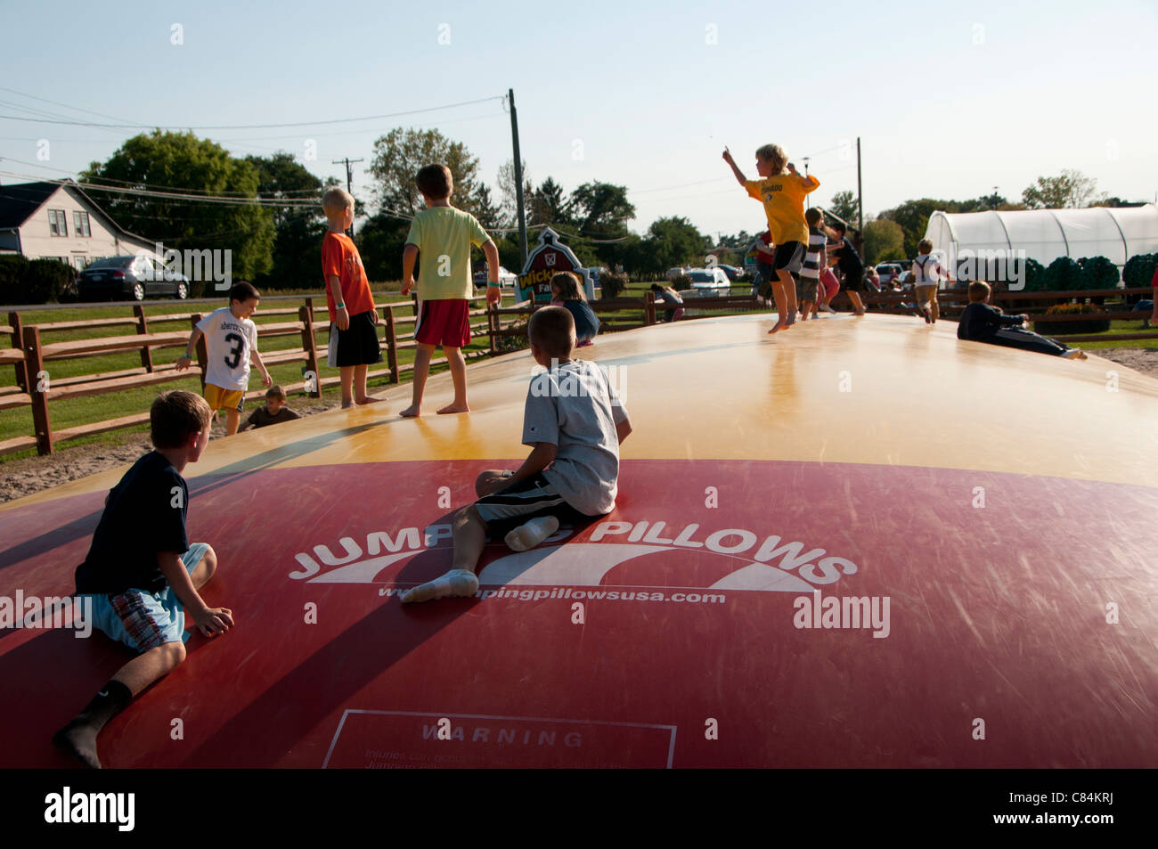 Children jumping on giant rubber pillow Stock Photo - Alamy