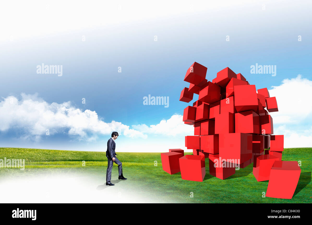 A man walking toward piled red boxes Stock Photo - Alamy