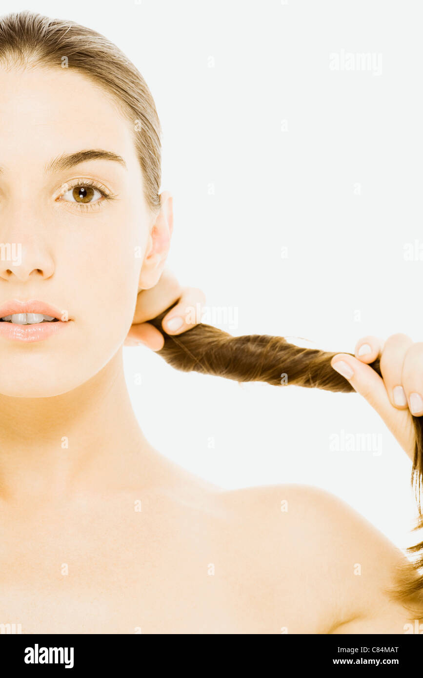 Woman twisting hair Stock Photo - Alamy