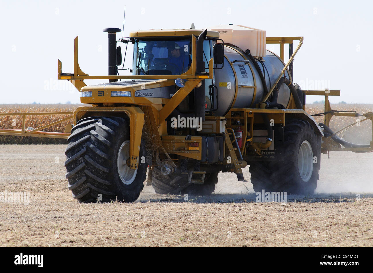 A farm field being sprayed with fertilizer after harvest Stock Photo ...
