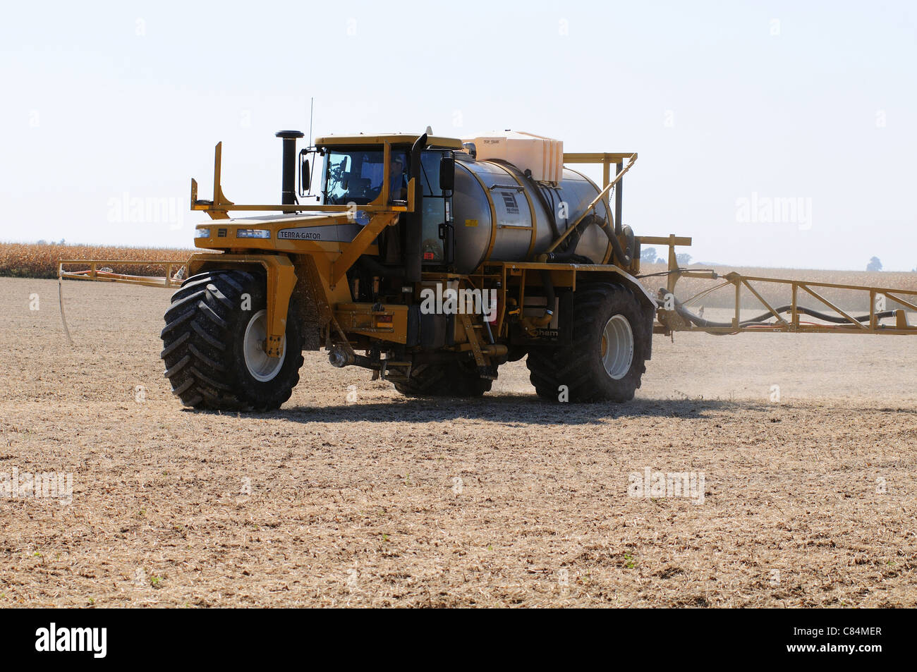 A farm field being sprayed with fertilizer after harvest Stock Photo ...