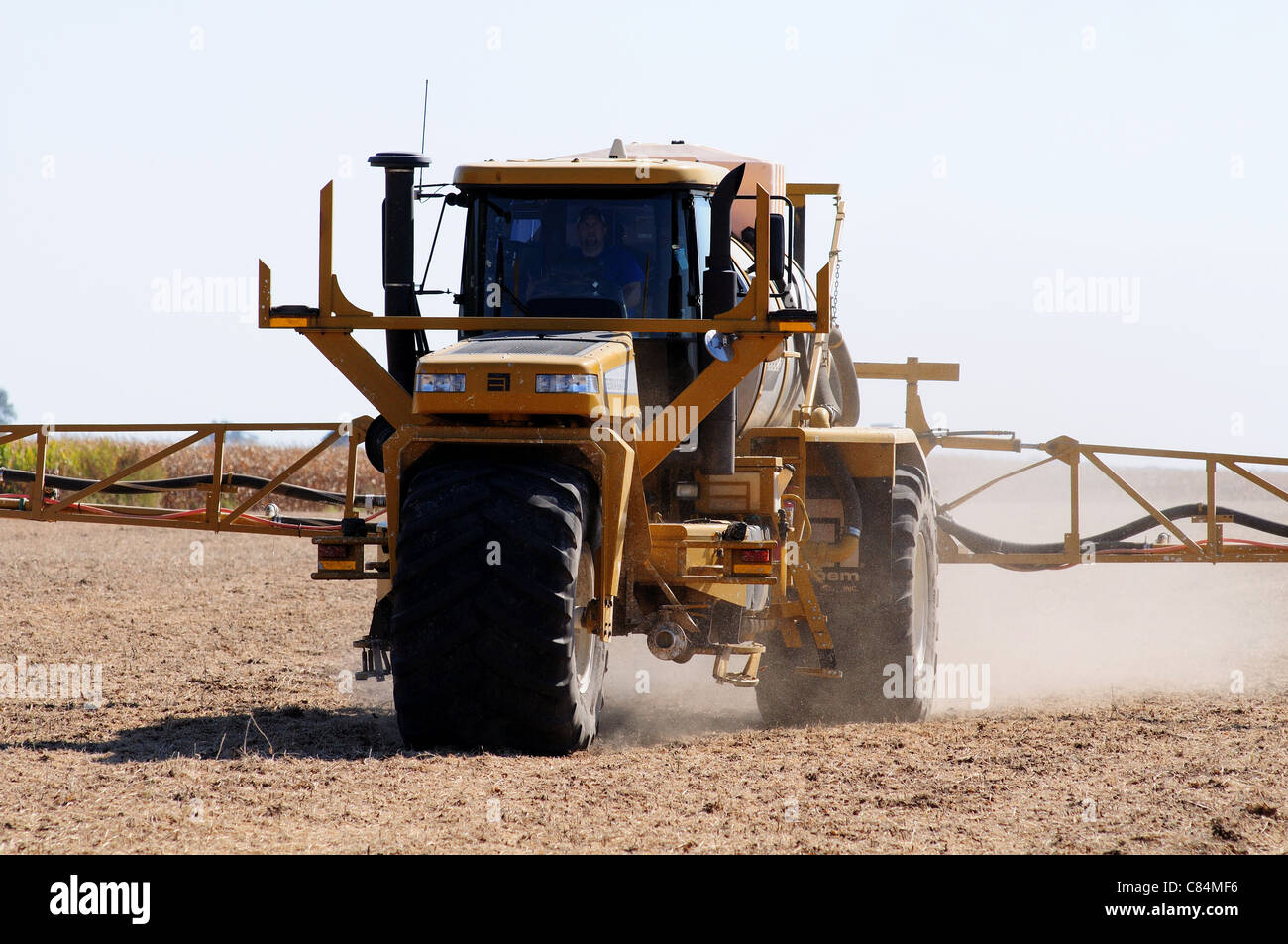A farm field being sprayed with fertilizer after harvest Stock Photo ...