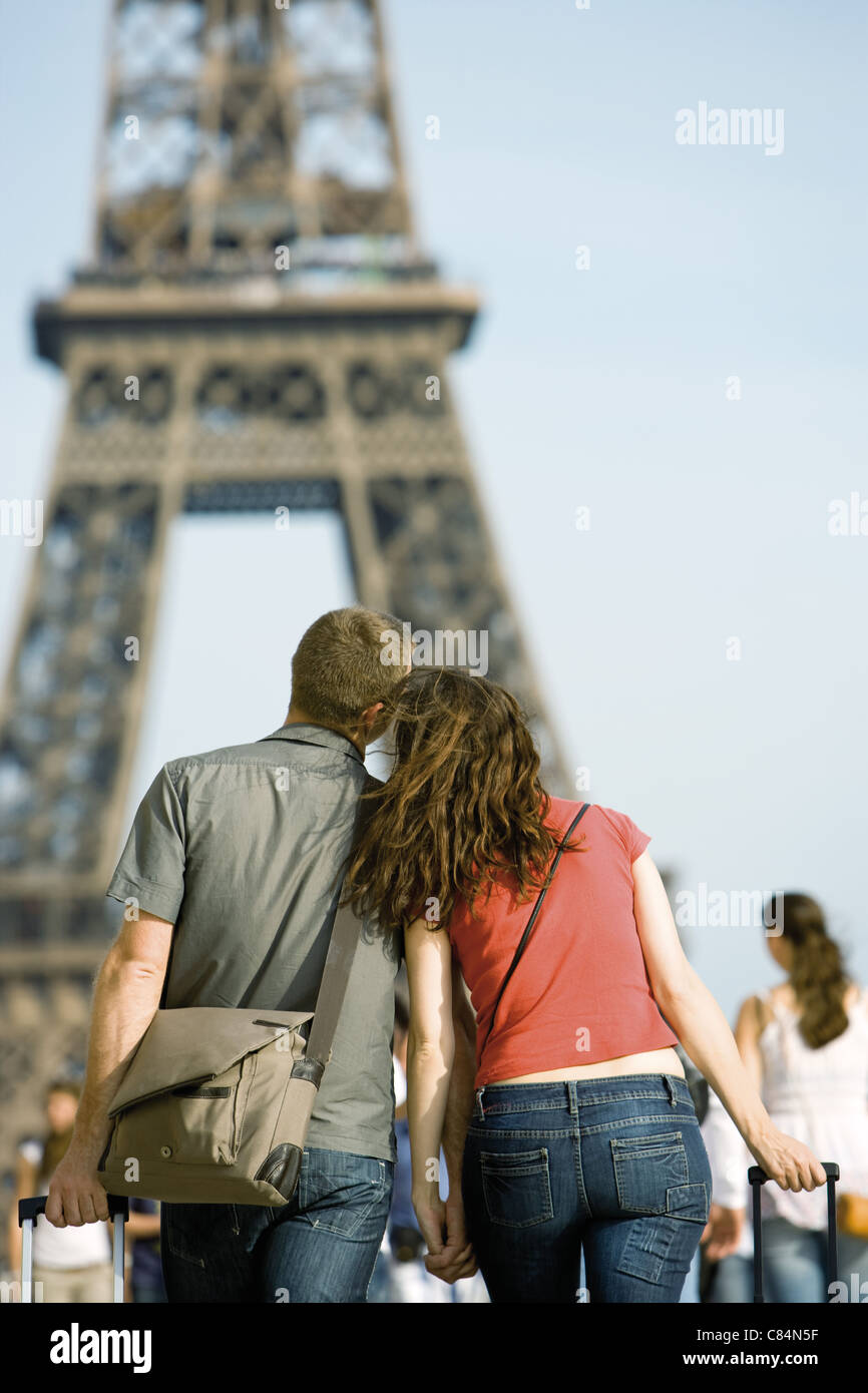 Tourist couple walking hand in hand toward Eiffel Tower, Paris, France ...