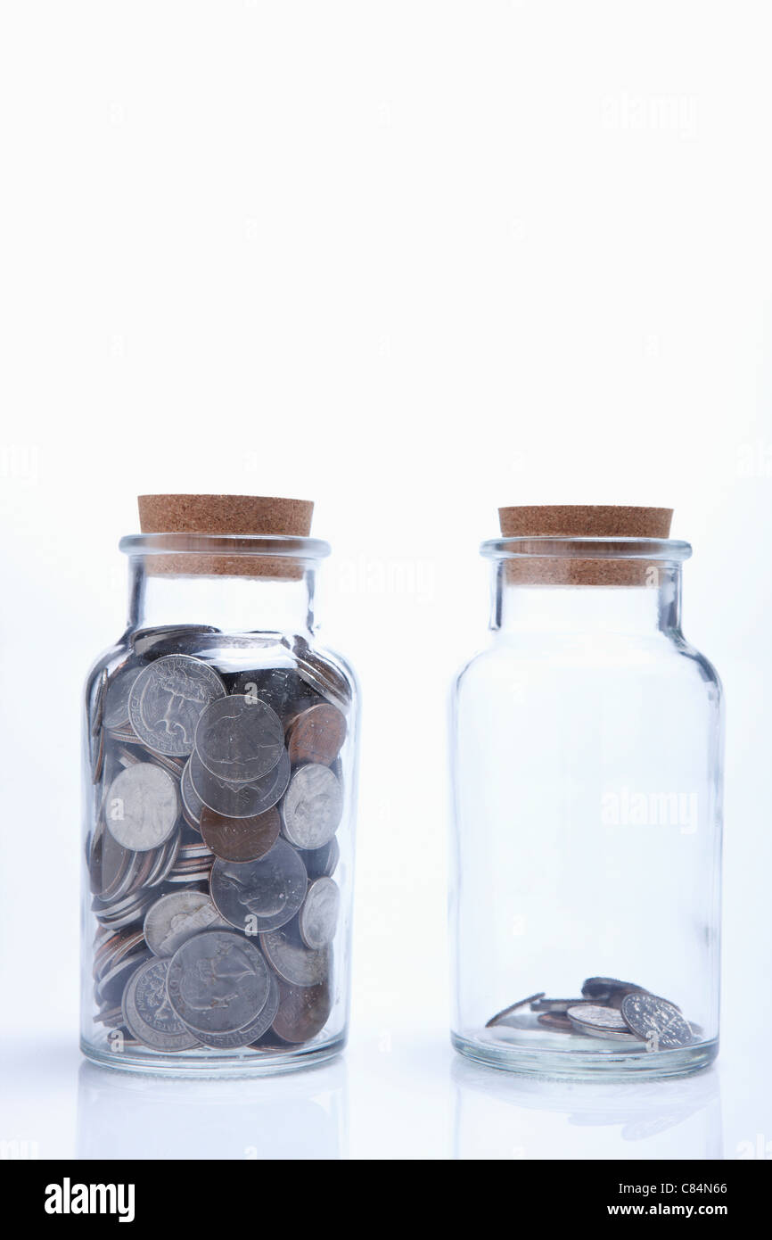 A bottle full of coins and another bottle being empty Stock Photo - Alamy