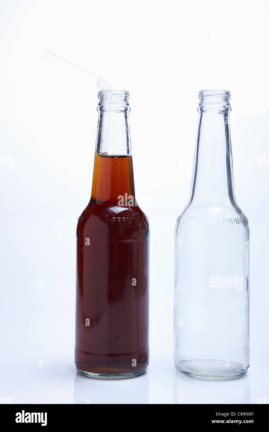 A bottle full of drink and another bottle being empty Stock Photo - Alamy