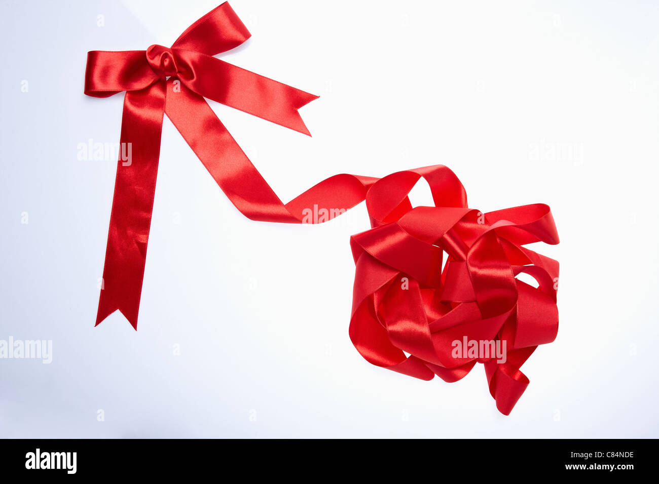 Tangled red ribbon Stock Photo - Alamy