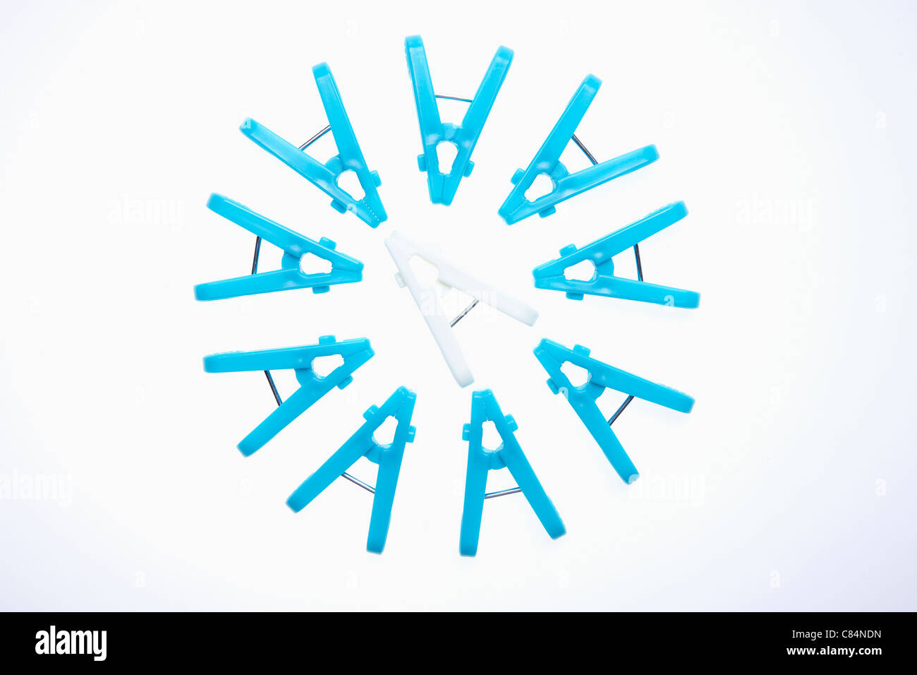 A white clothespin with blue clothespins around Stock Photo - Alamy