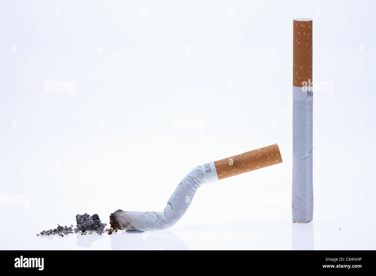 Stacked cigarettes with other scatted cigarettes around Stock Photo - Alamy