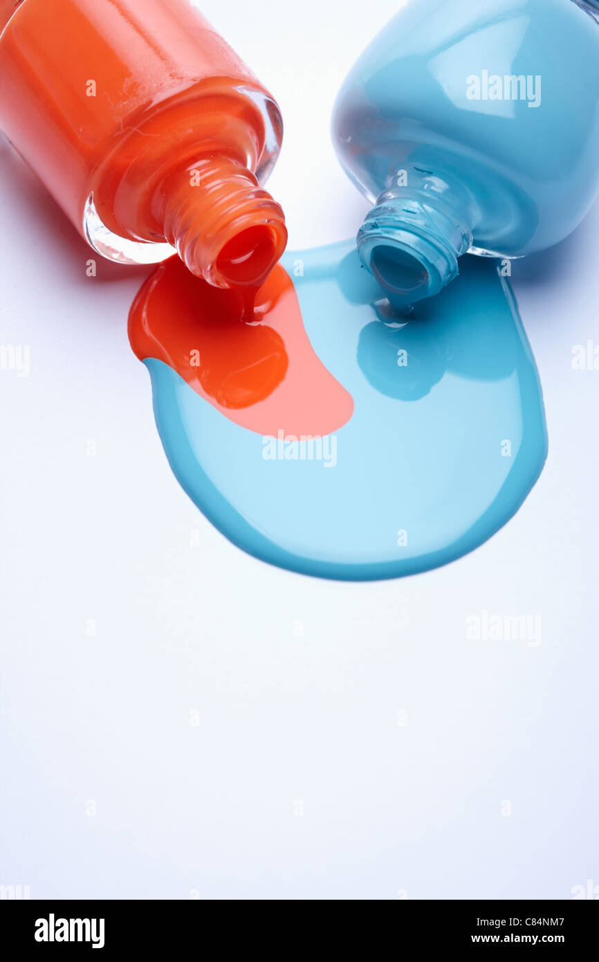 Orange and blue nail polish from fallen bottles Stock Photo - Alamy