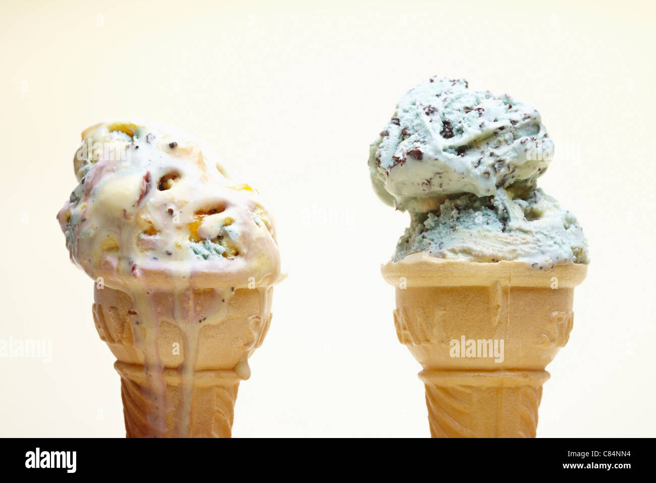 Melting ice cream cone and another cold ice cream cone Stock Photo - Alamy