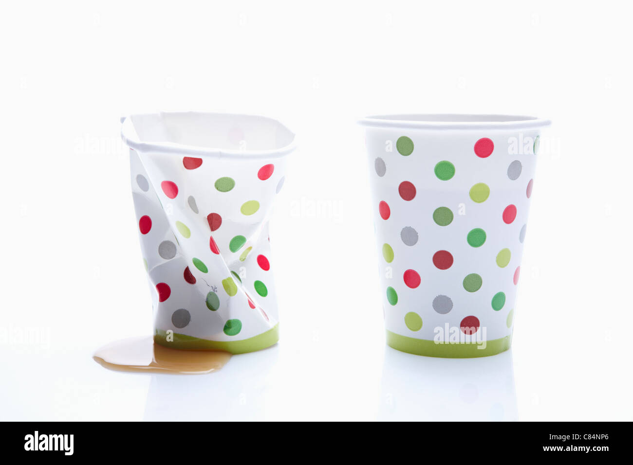 Crumpled dot patterned paper cup and normal dot patterned paper cup ...