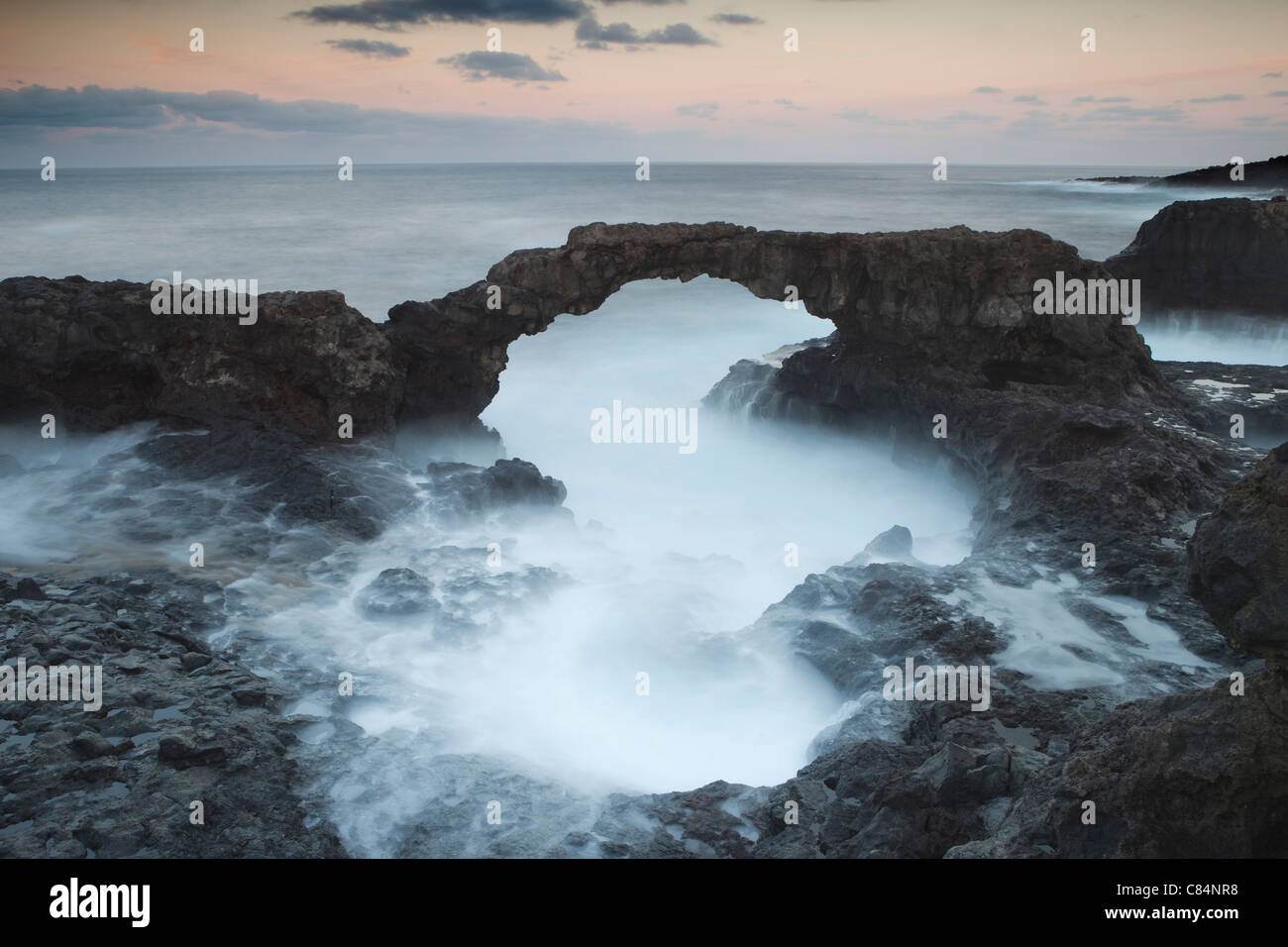 Waves washing over rocks on beach Stock Photo - Alamy