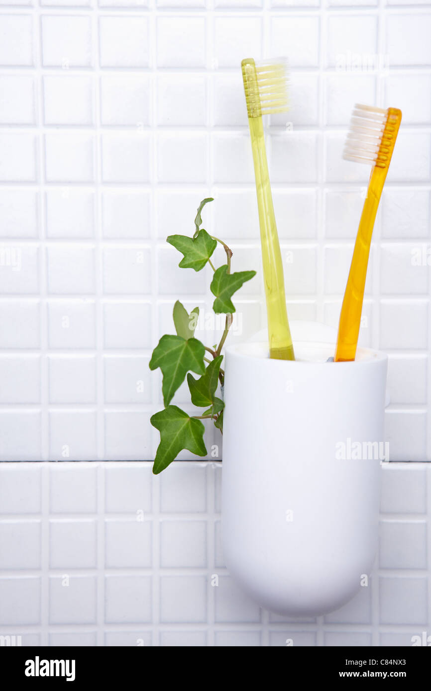 Tooth brushes in cup hi-res stock photography and images - Alamy