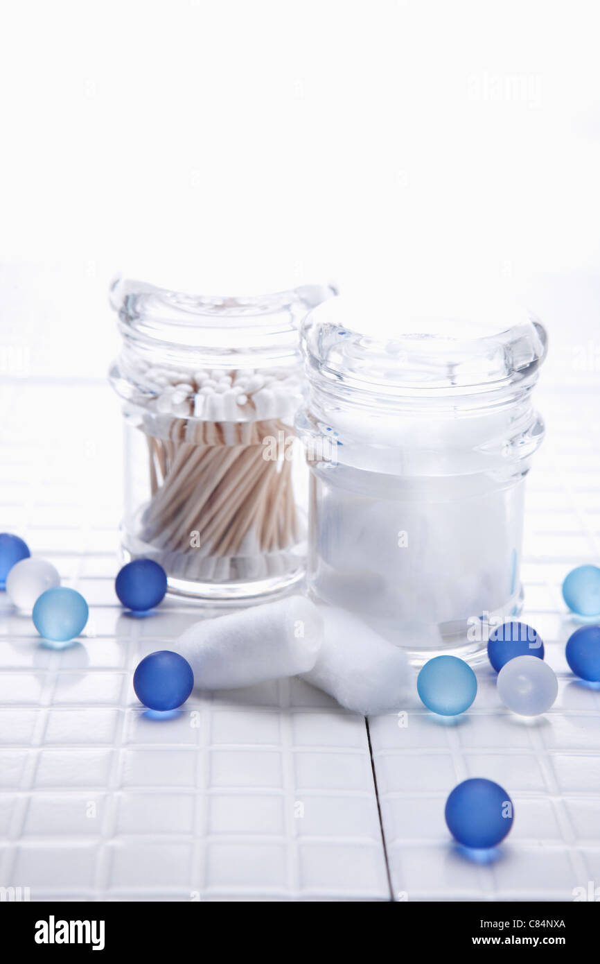 cotton swap and cotton in the plastic containers with blue balls around ...