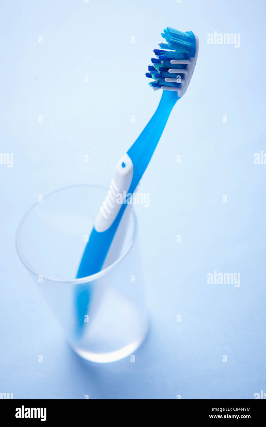 A blue tooth brush in a plastic cup Stock Photo - Alamy