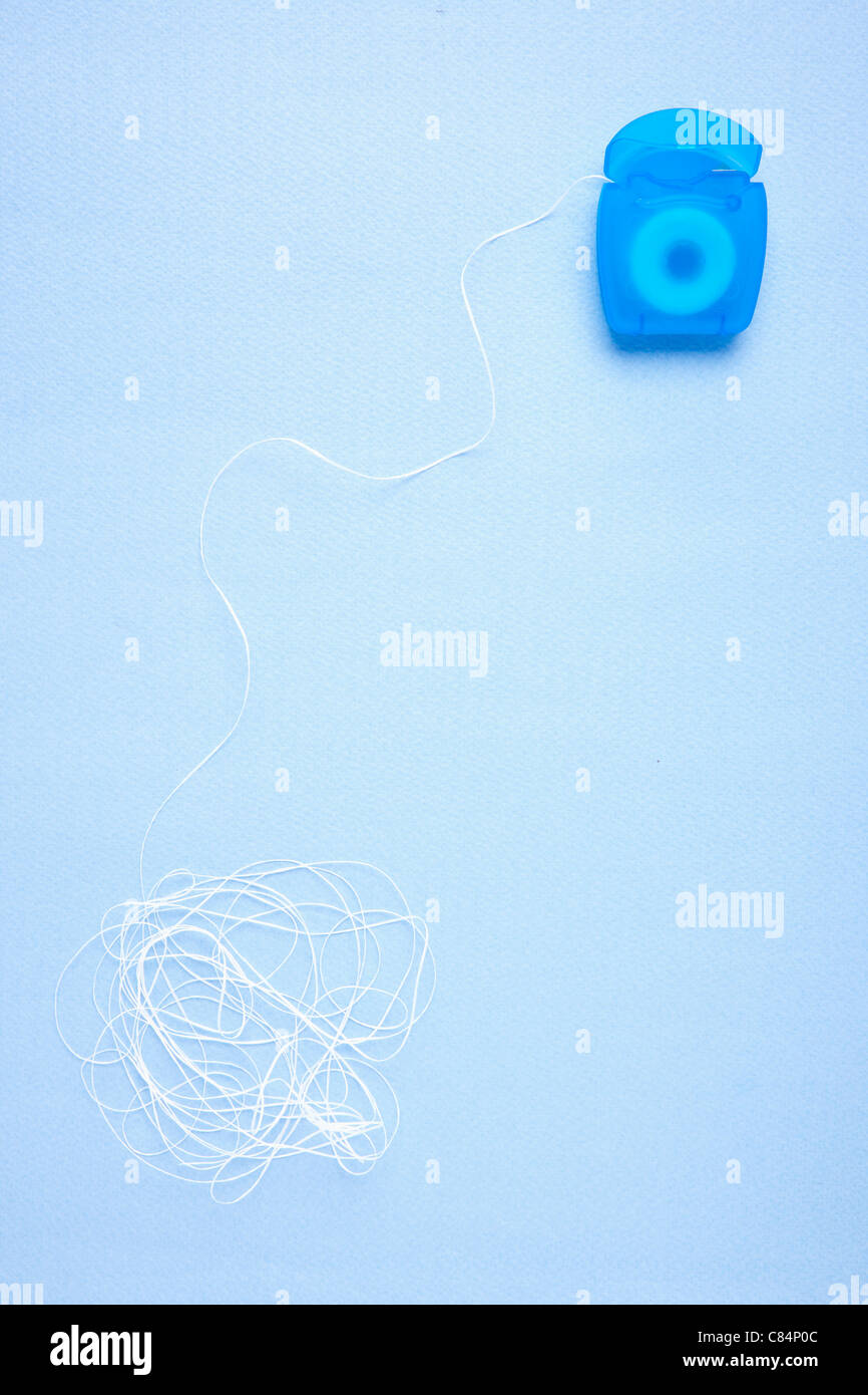 A tangled blue dental floss Stock Photo - Alamy