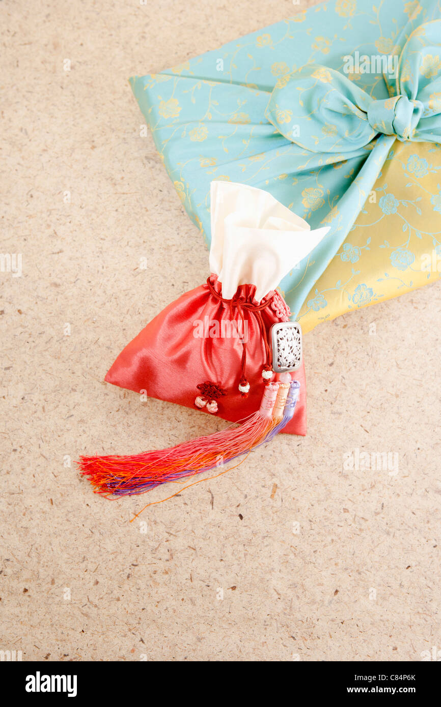 A red lucky bag with blue wrapped package in cloth Stock Photo - Alamy