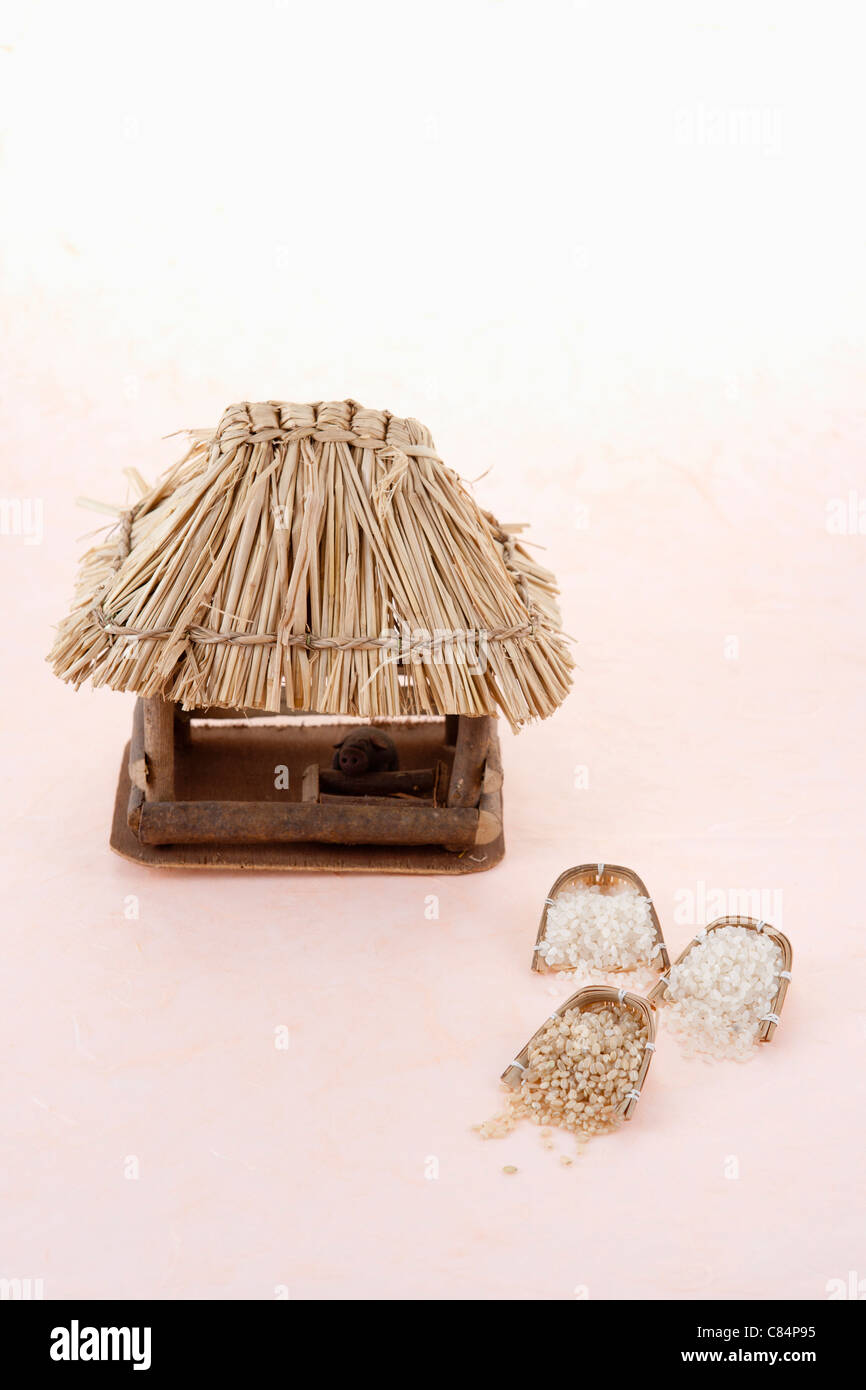 A straw house with small strainers Stock Photo - Alamy