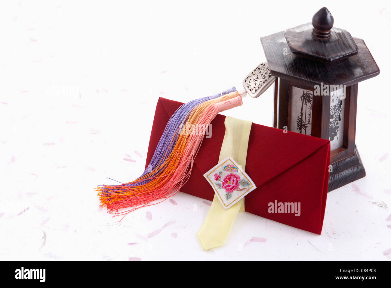 A red traditional envelope, clothes accessory, and lamp Stock Photo - Alamy