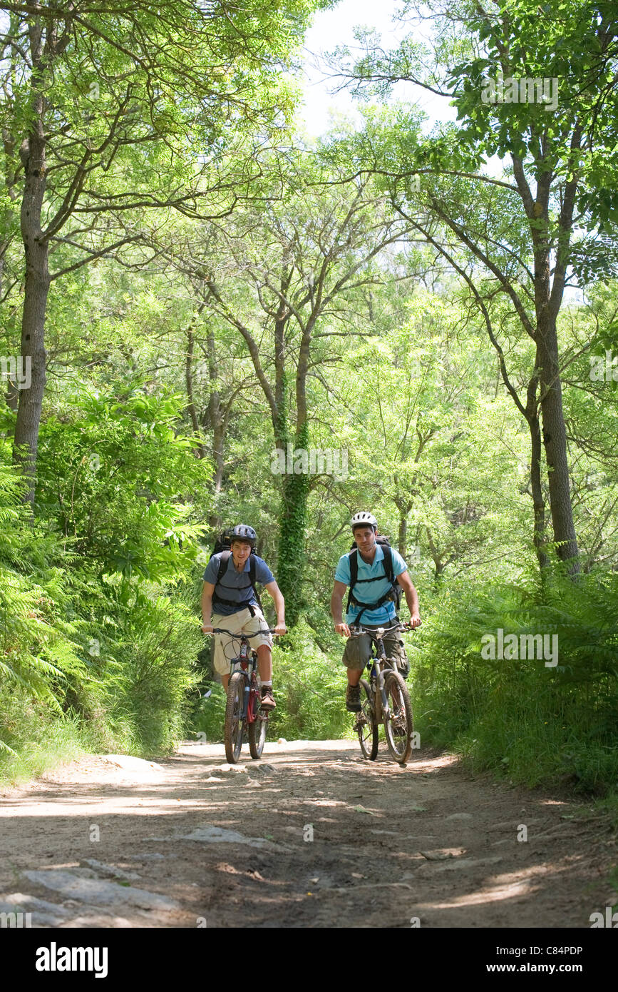 Men riding bicycles in woods Stock Photo - Alamy