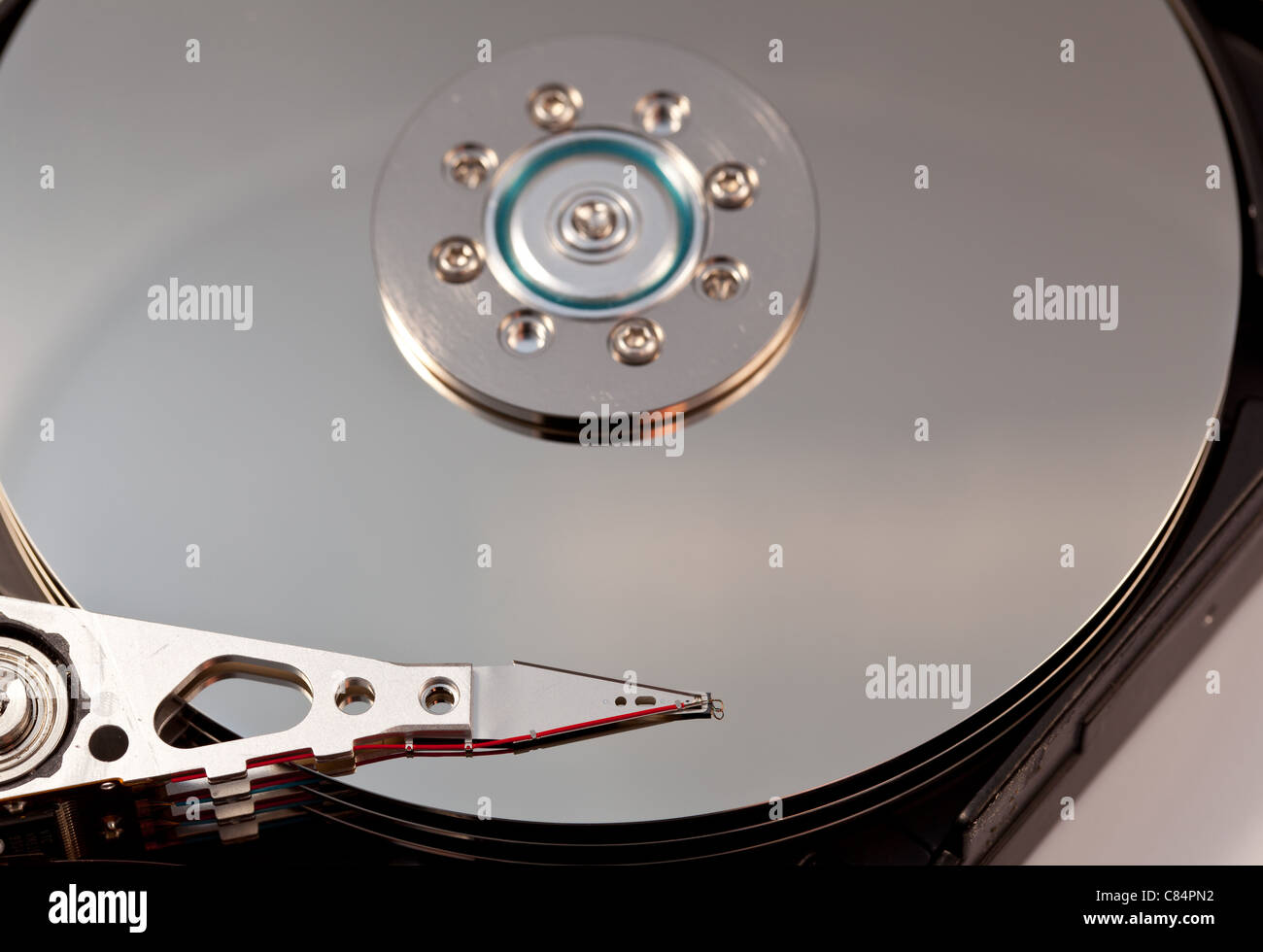 Magnetic disc inside a computer hd unit showing mirror surface of the ...