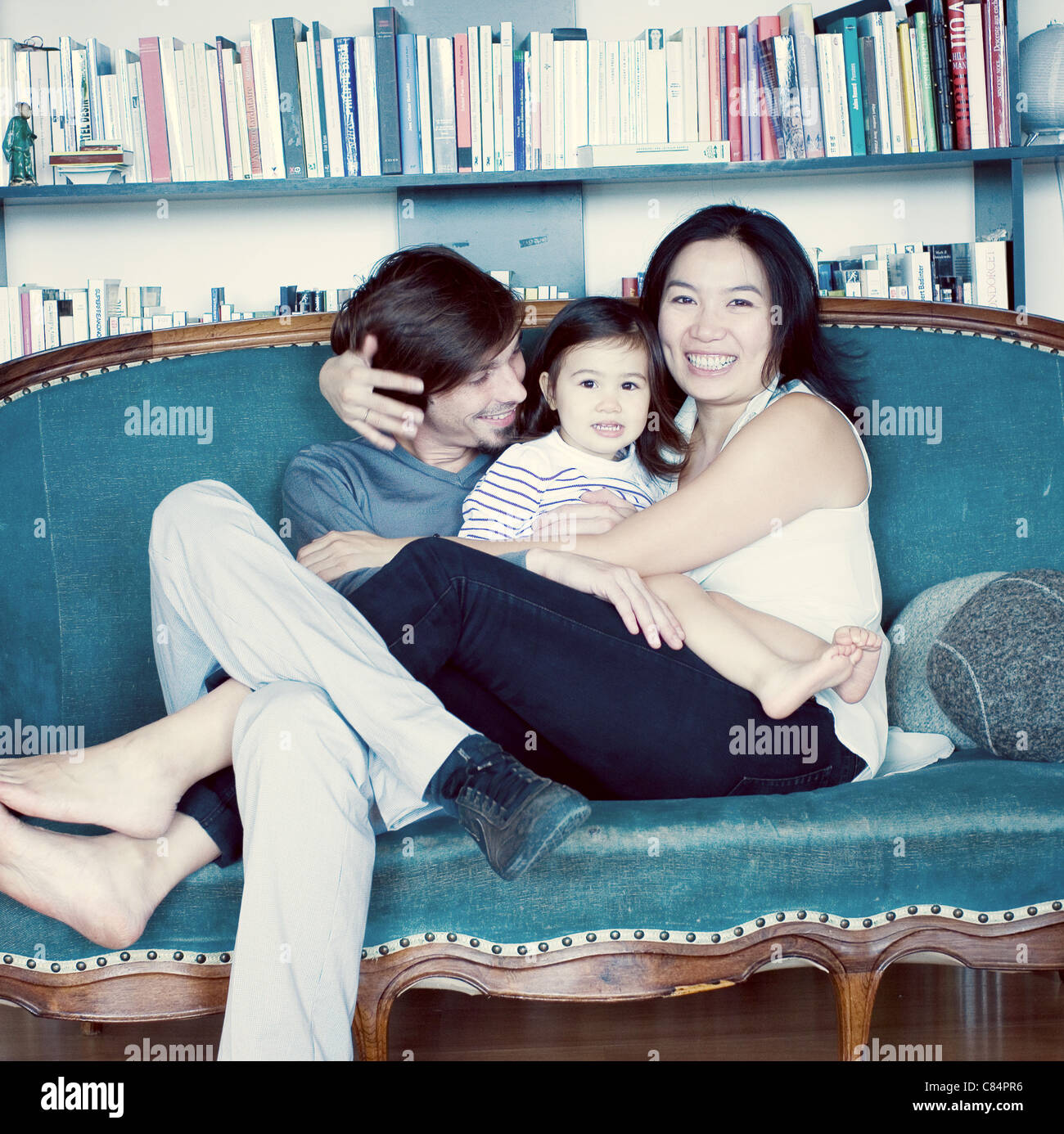 Family relaxing on couch, portrait Stock Photo - Alamy