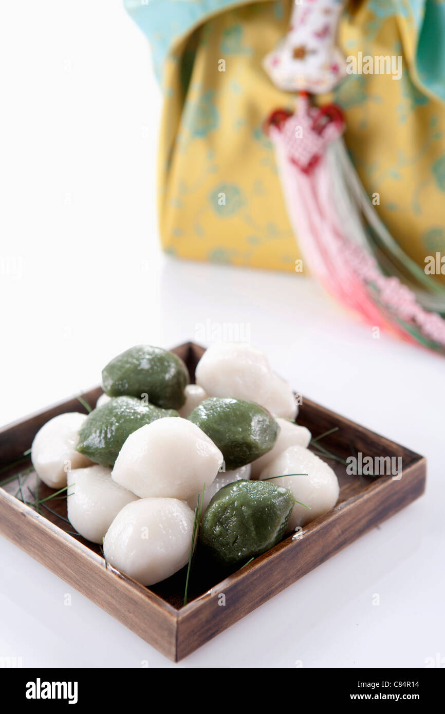 Rice cake with traditional wrapped package behind Stock Photo - Alamy