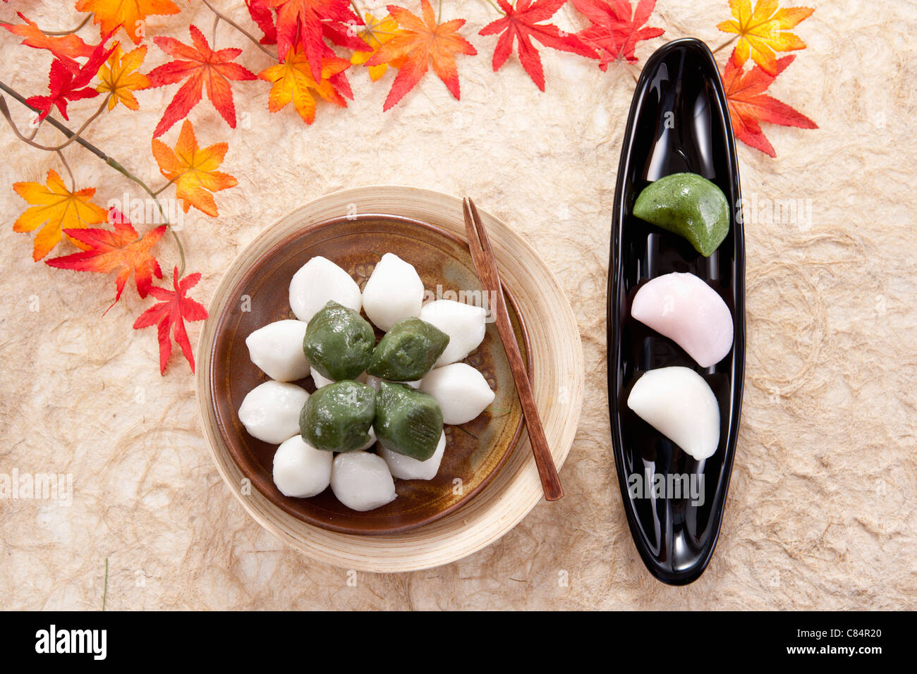 Rice cake with colored leaves around Stock Photo - Alamy